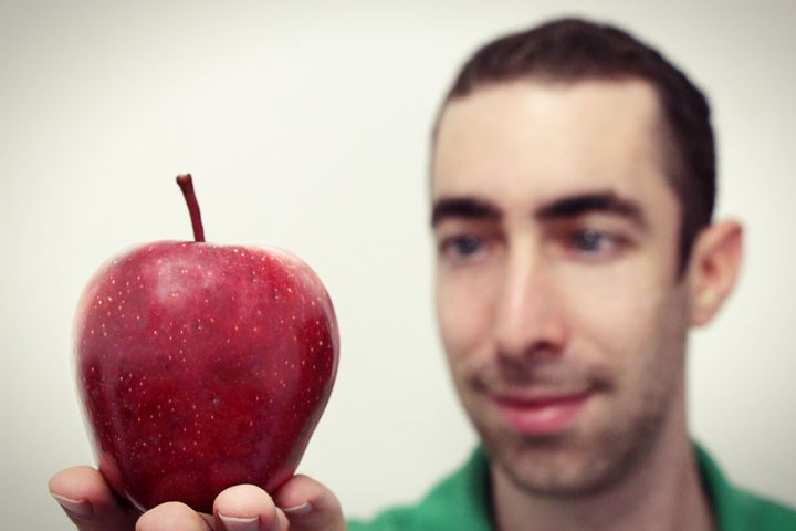 Man smiling and looking at red apple - Maor Winetrob - Photography ...